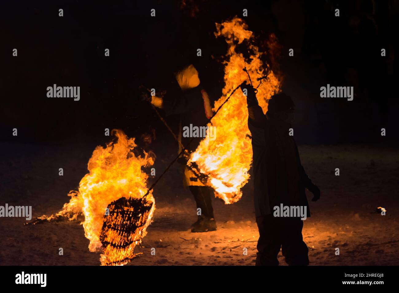 Swinging burning rice straw bags filled with charcoal at Hiburi ...