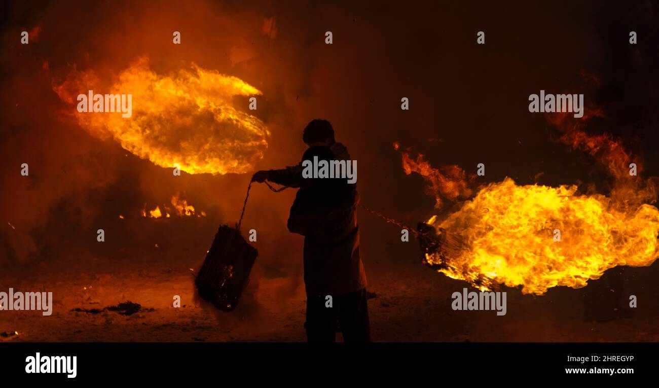 Swinging burning rice straw bags filled with charcoal at Hiburi ...