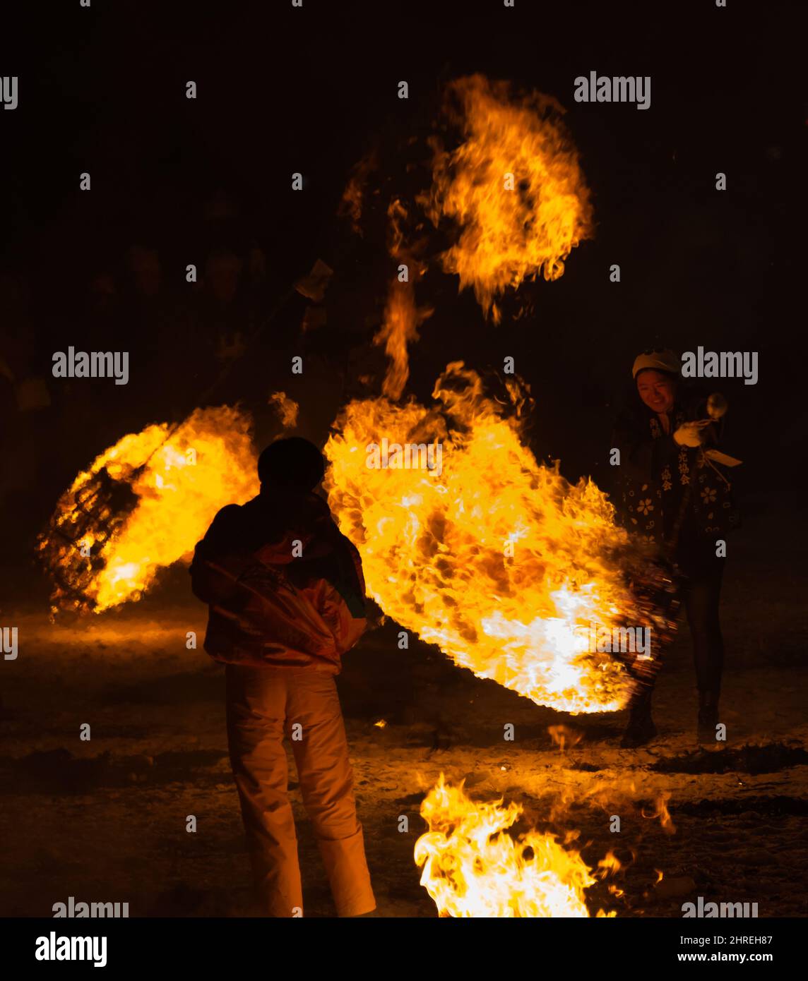 Swinging burning rice straw bags filled with charcoal at Hiburi ...