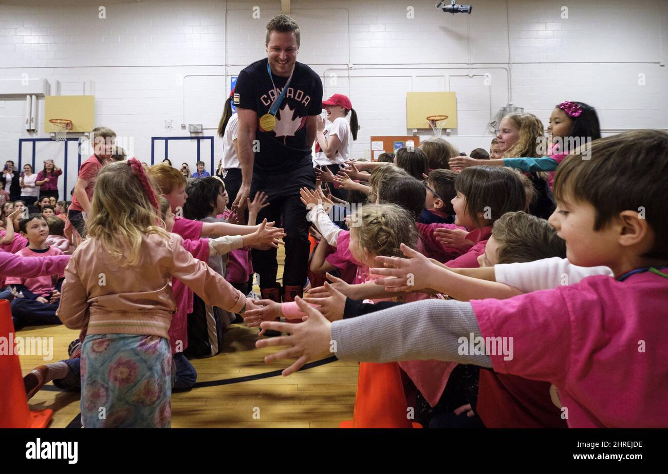 Gold medalists in bobsleigh Justin Kripps is welcomed by students to a ...
