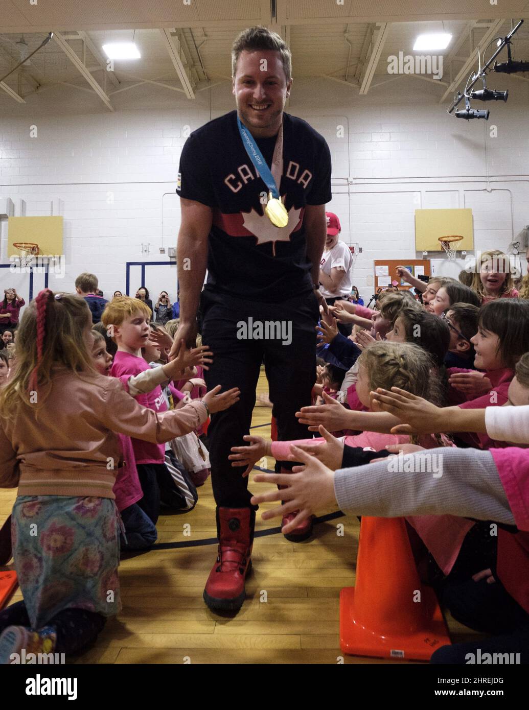 Gold medalists in bobsleigh Justin Kripps is welcomed by students to a ...