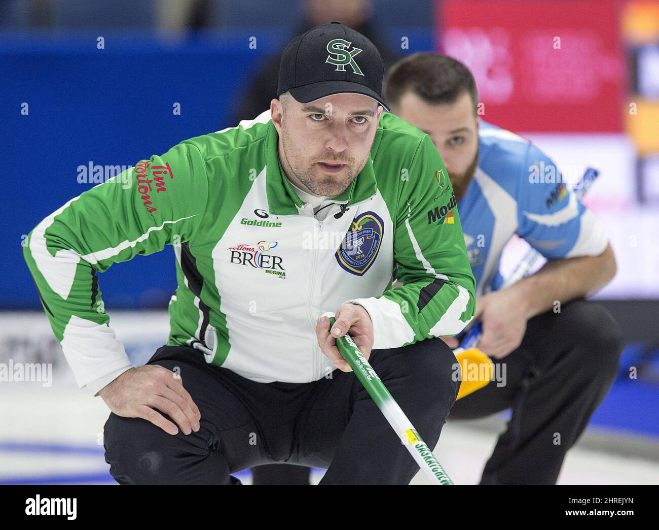Saskatchewan skip Steve Laycock, left, watches a rock as Quebec second ...