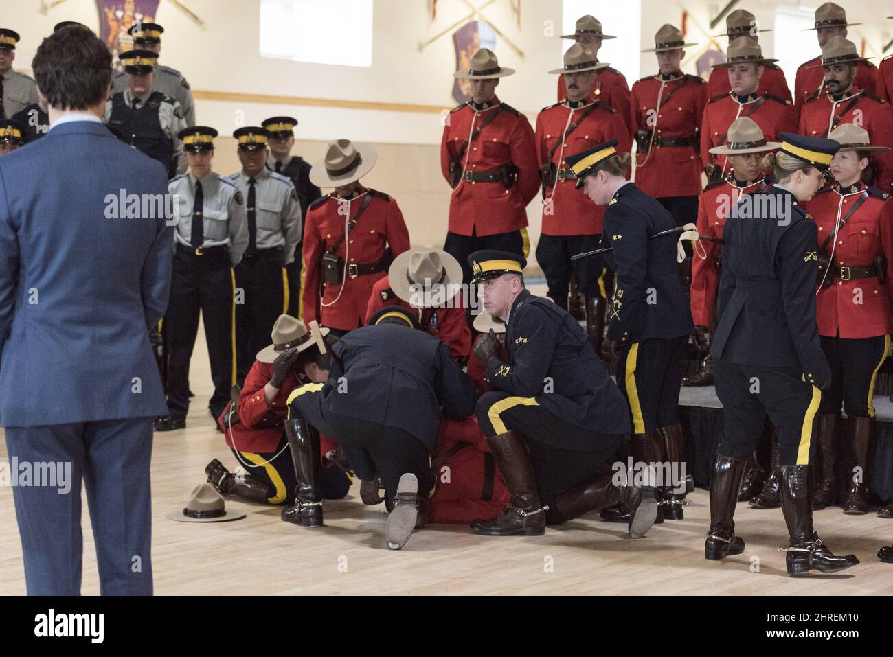 Prime Minister Justin Trudeau, left, looks on as RCMP members attend to ...