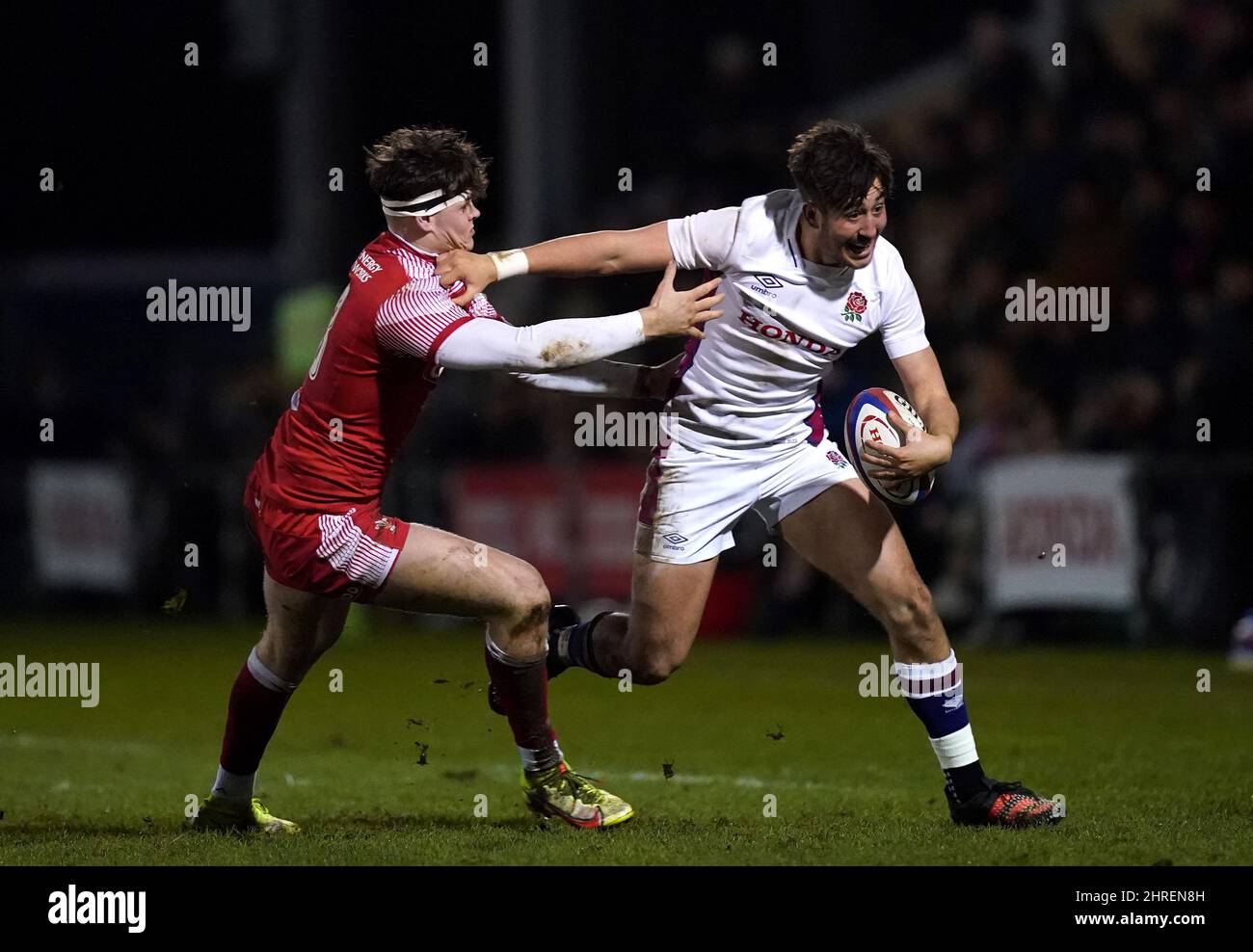 England's Ethan Grayson (right) gets away from Wales' Eddie James ...