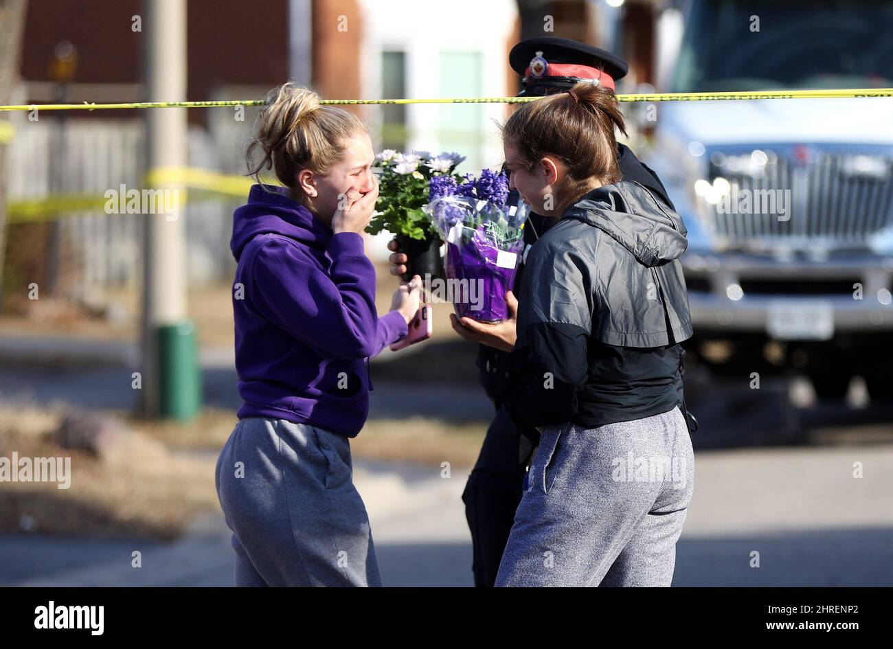 Mackenzie Cooper, 14, left and Cailynn Denoon hand over flowers in Ajax ...
