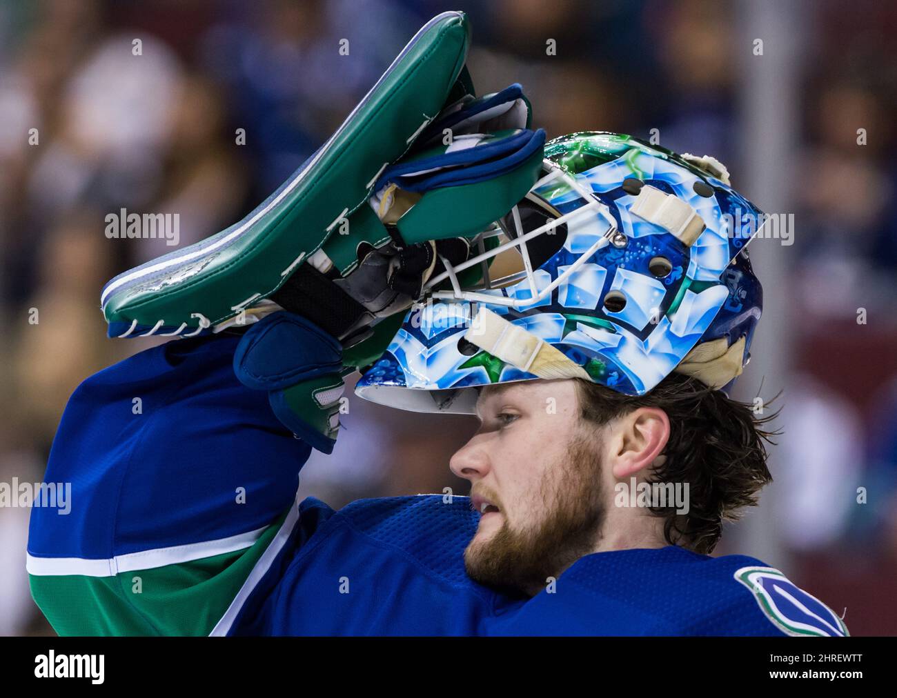 Vancouver Canucks' goalie Thatcher Demko puts on his helmet during ...