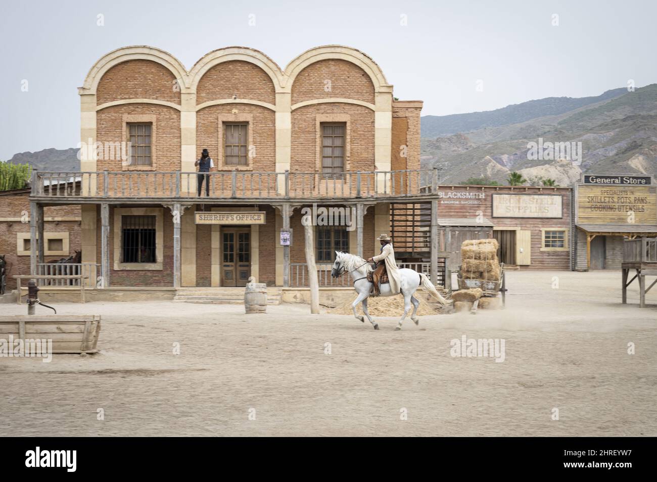 A wild west movie set with men fighting and a galloping horse Stock ...