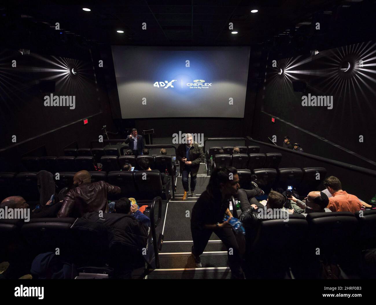 People mill about inside a Cineplex theatre as it opens its first 4DX ...