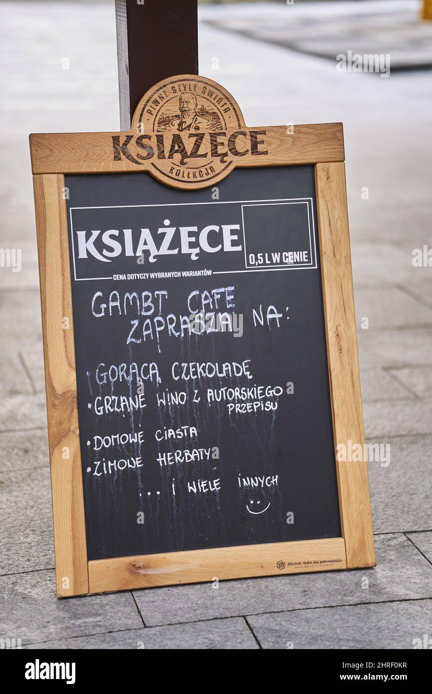 Chalkboard with the Ksiazece brand beer logo with offers by a small ...