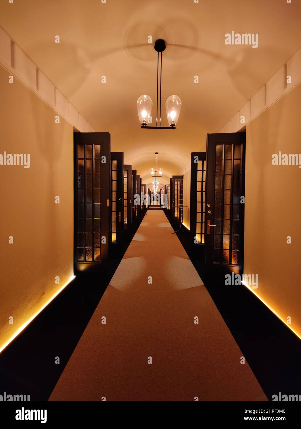 Long corridor with open doors and lights Stock Photo - Alamy