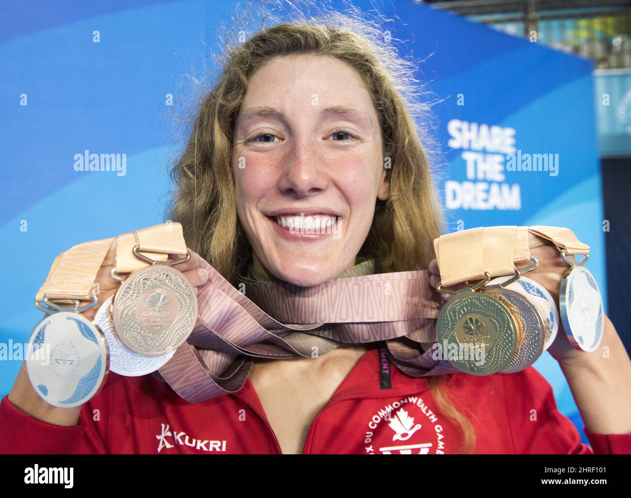 Canada's Taylor Ruck holds up her eight swimming medals at the ...