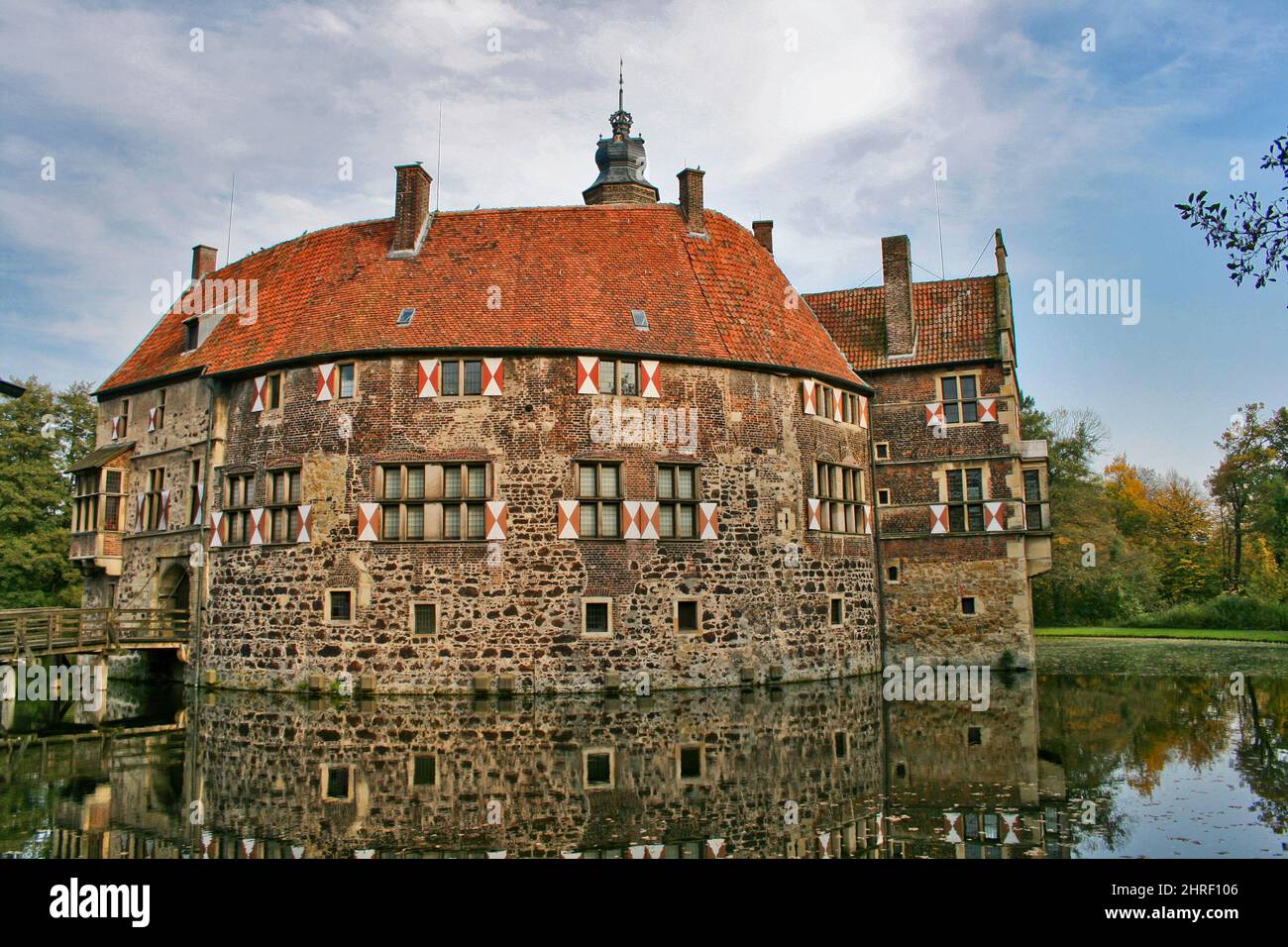 castle a moated castle on a cloudy day in autumn with reflection in the ...