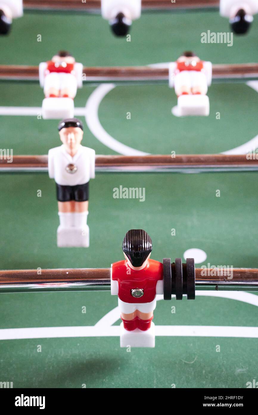 Vertical shot of the figures of table football players in uniforms ...