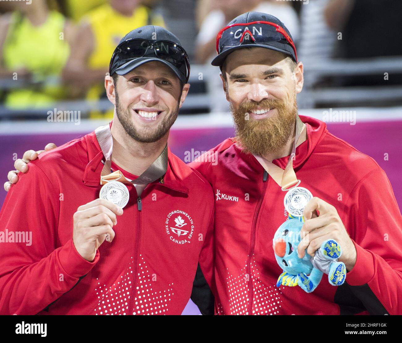 Canada's Samuel Pedlow, right, and Sam Schachter hold up their silver ...
