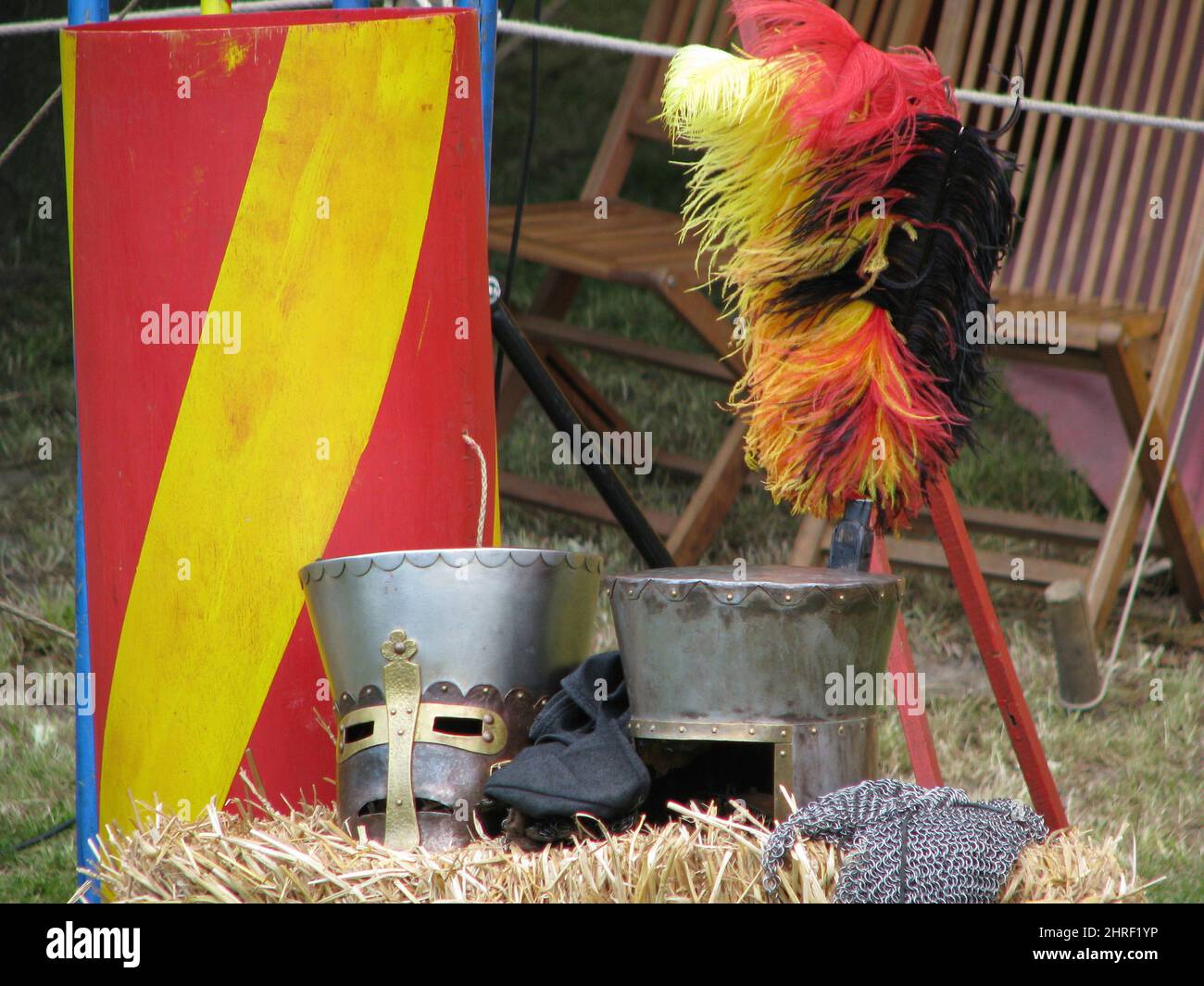 Knight helmets lying on straw in the background an old flag. Taken at a ...