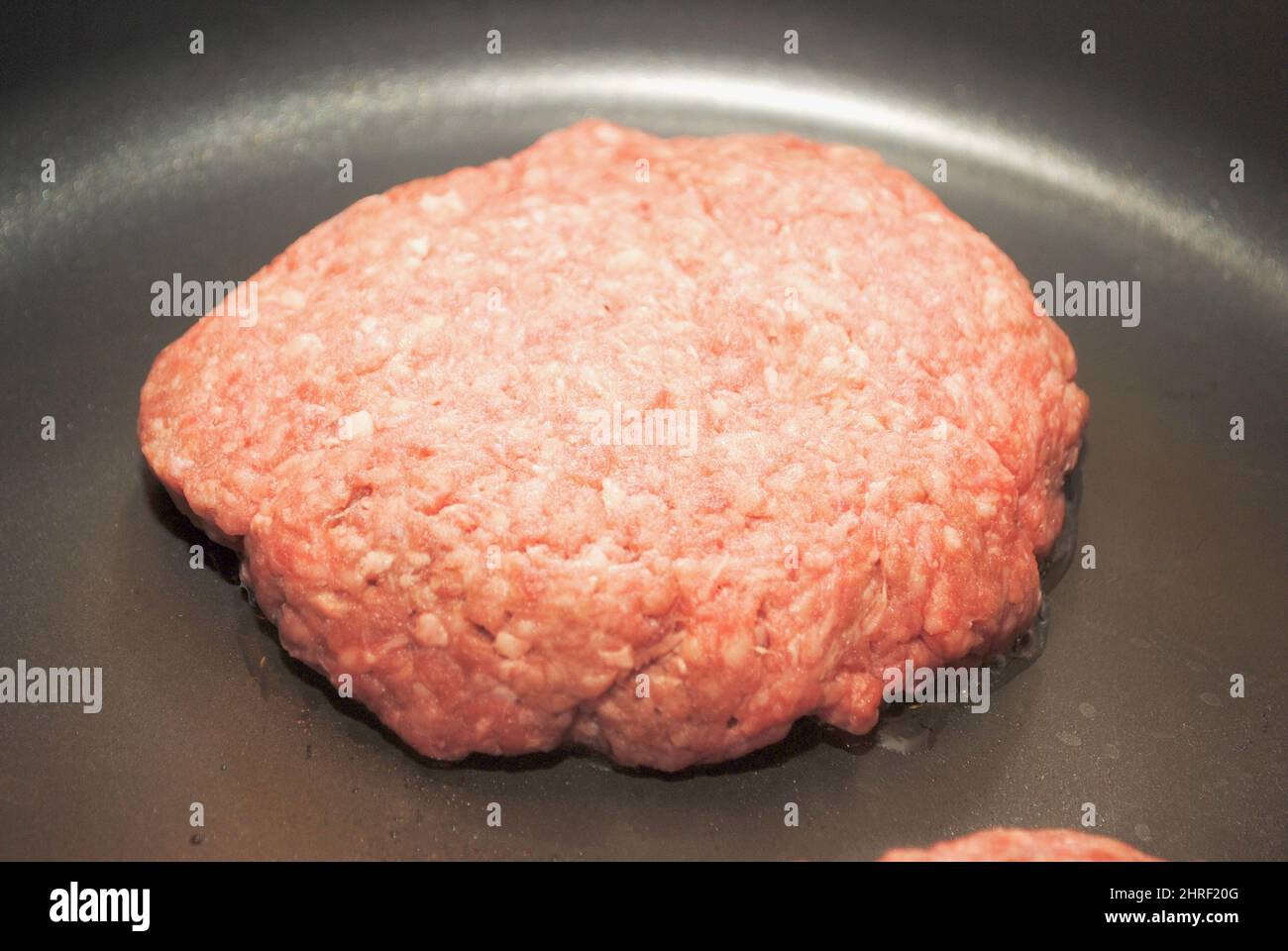 Frying Burgers in a Black Pan Stock Photo - Alamy