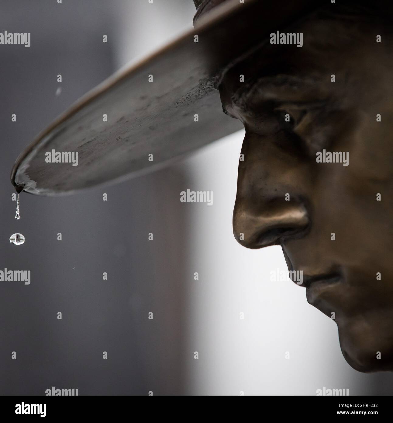 Water drips from the stetson on a statue of a mountie outside the Royal ...