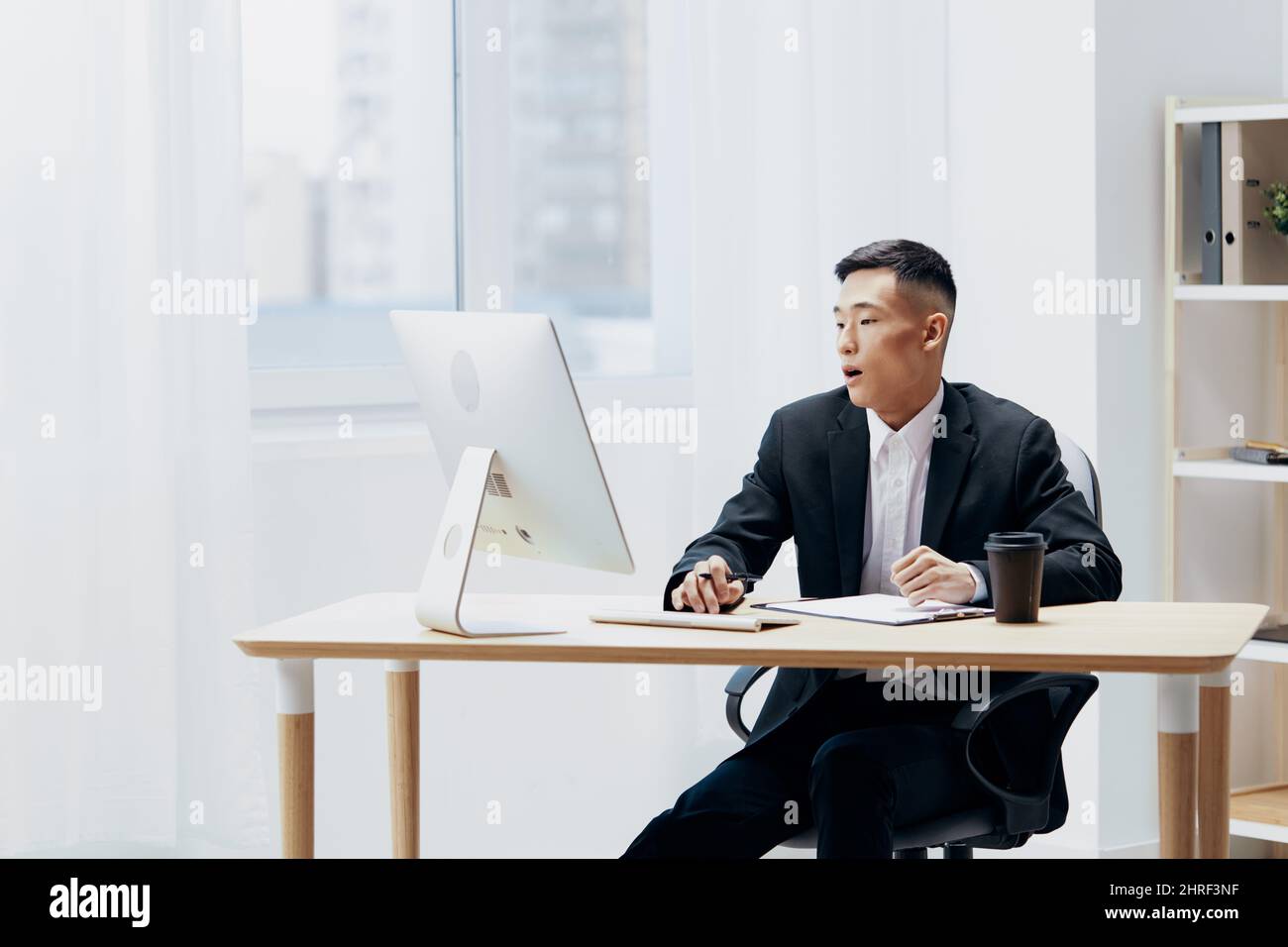 manager sitting at a desk in front of a computer emotions technologies ...