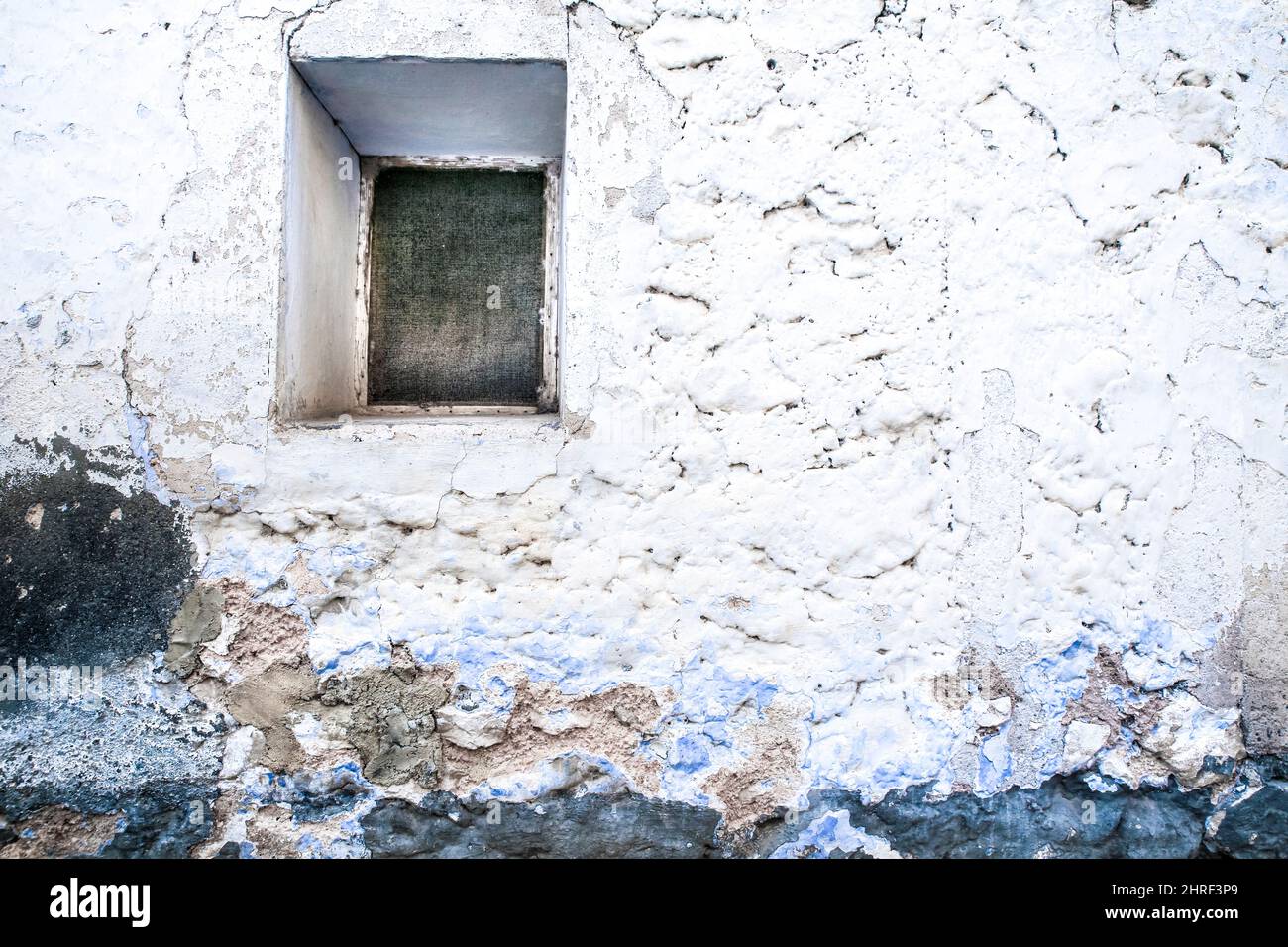 Old chipped house facade with little window Stock Photo - Alamy