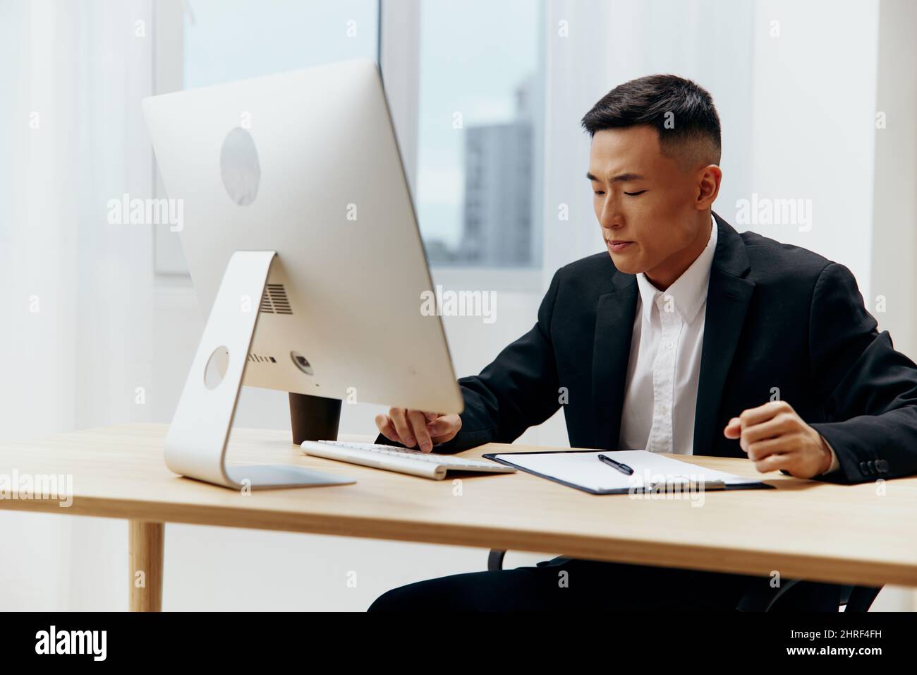 Asian man works at the computer emotion office Lifestyle Stock Photo ...
