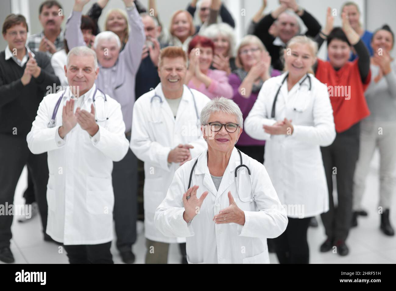 Group doctors and patients clapping their hands to celebrate recovery ...