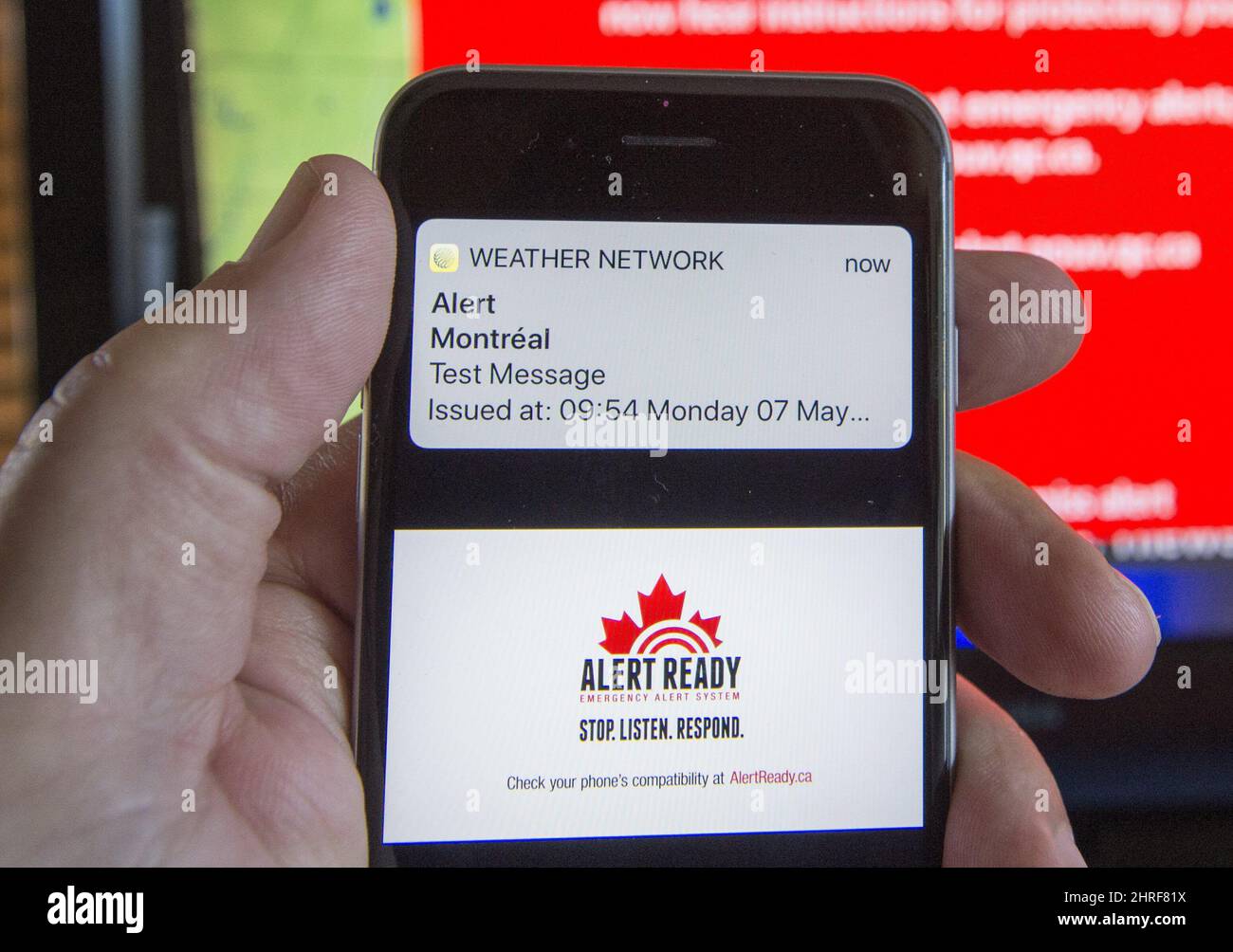 A smartphone and a television receive visual and audio alerts to test ...