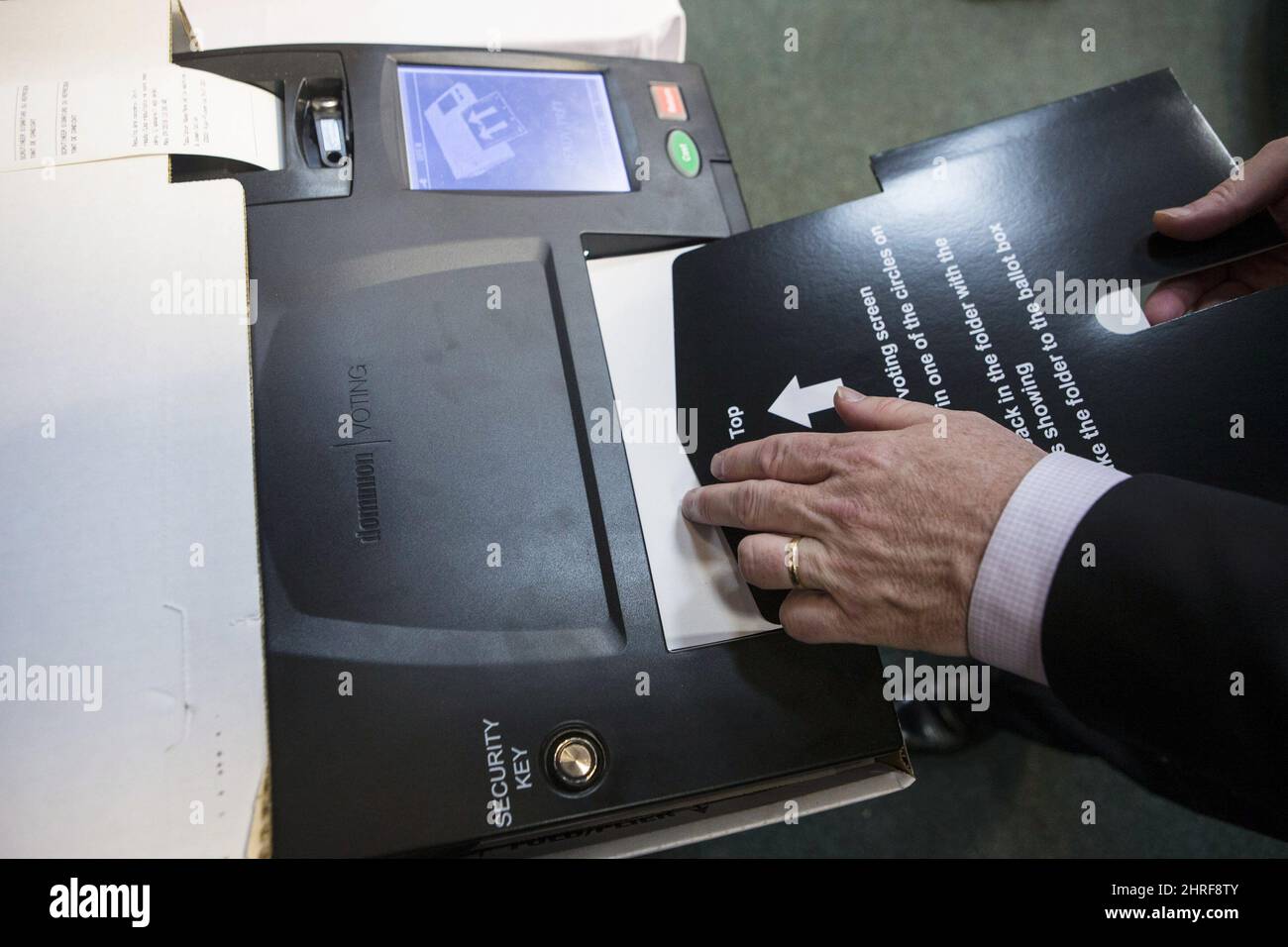 Ontario's Chief Electoral Officer Greg Essensa slides a ballot into a ...