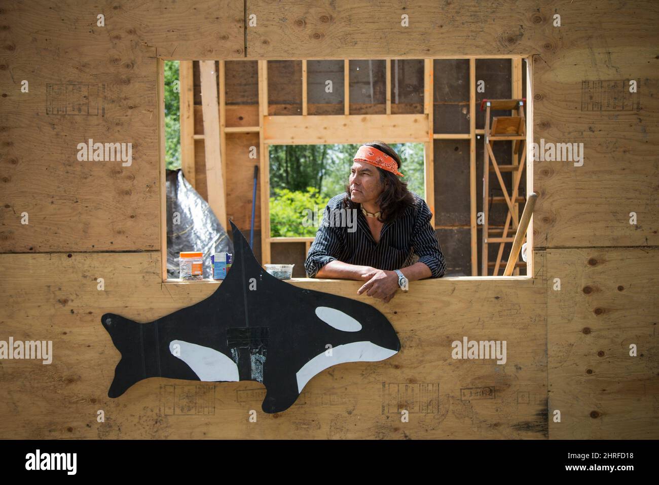 Protester Johnny Lee takes a break from building a enclosure outside ...