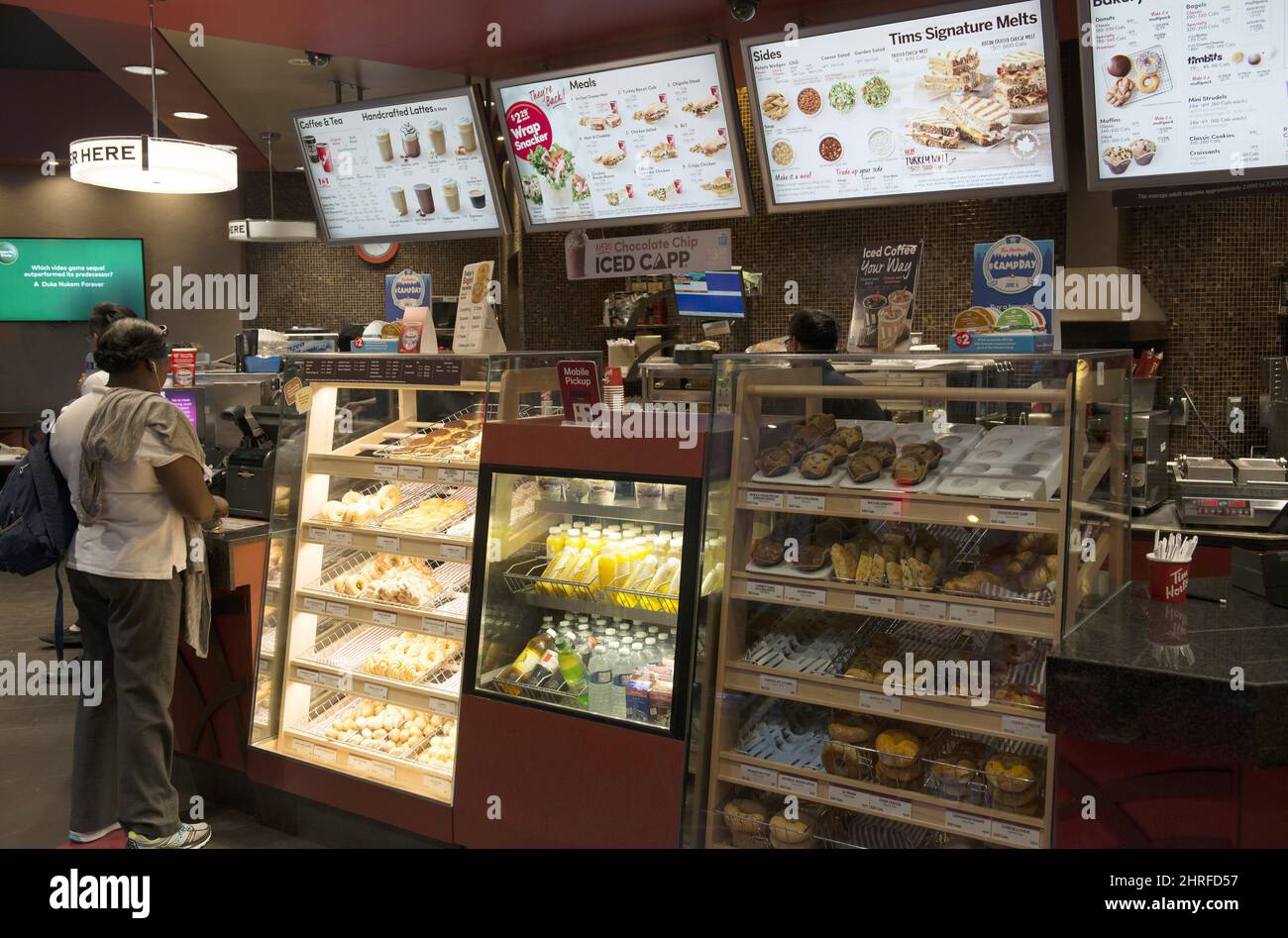 A customer places her orders at a Tim Hortons restaurant in Toronto on ...