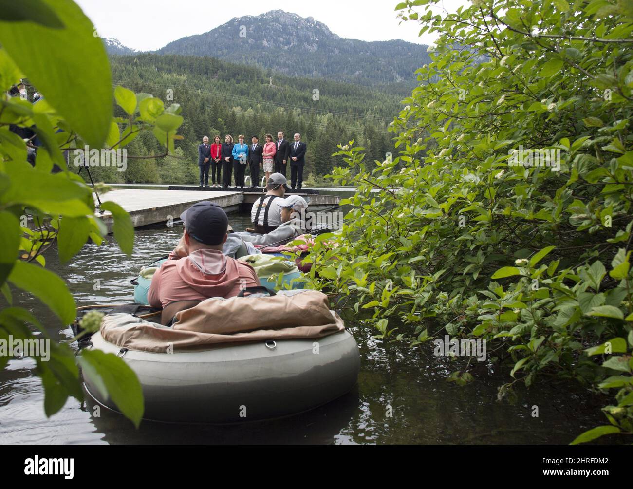 Fly fishermen sitting in their tubes look on as Director General ...