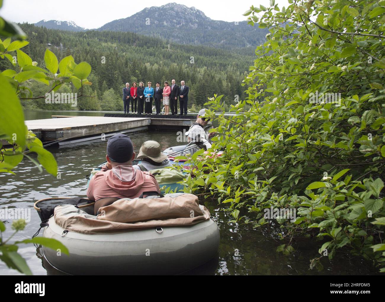 Fly fishermen sitting in their tubes look on as Director General ...