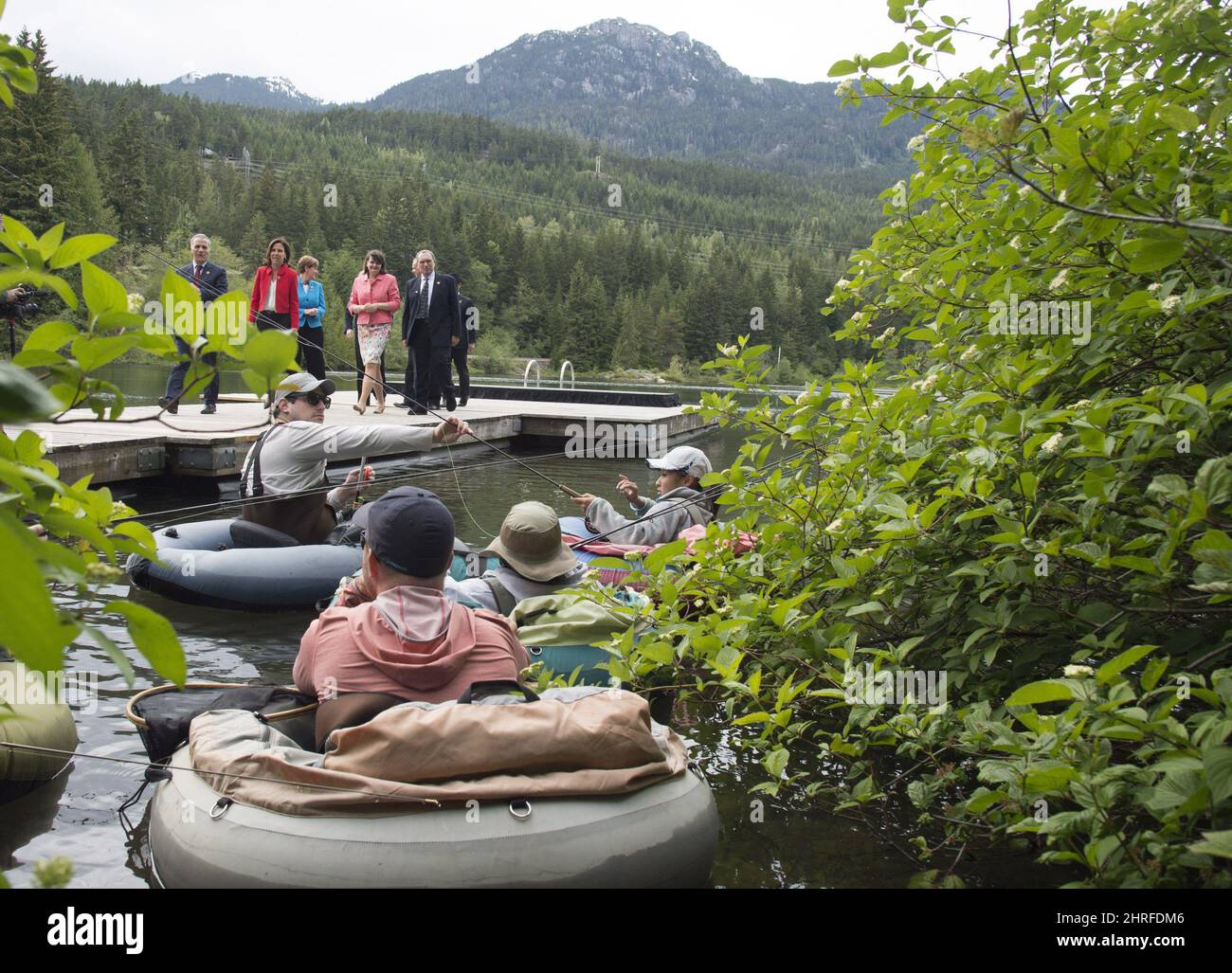 Fly fishermen sitting in their tubes look on as Director General ...