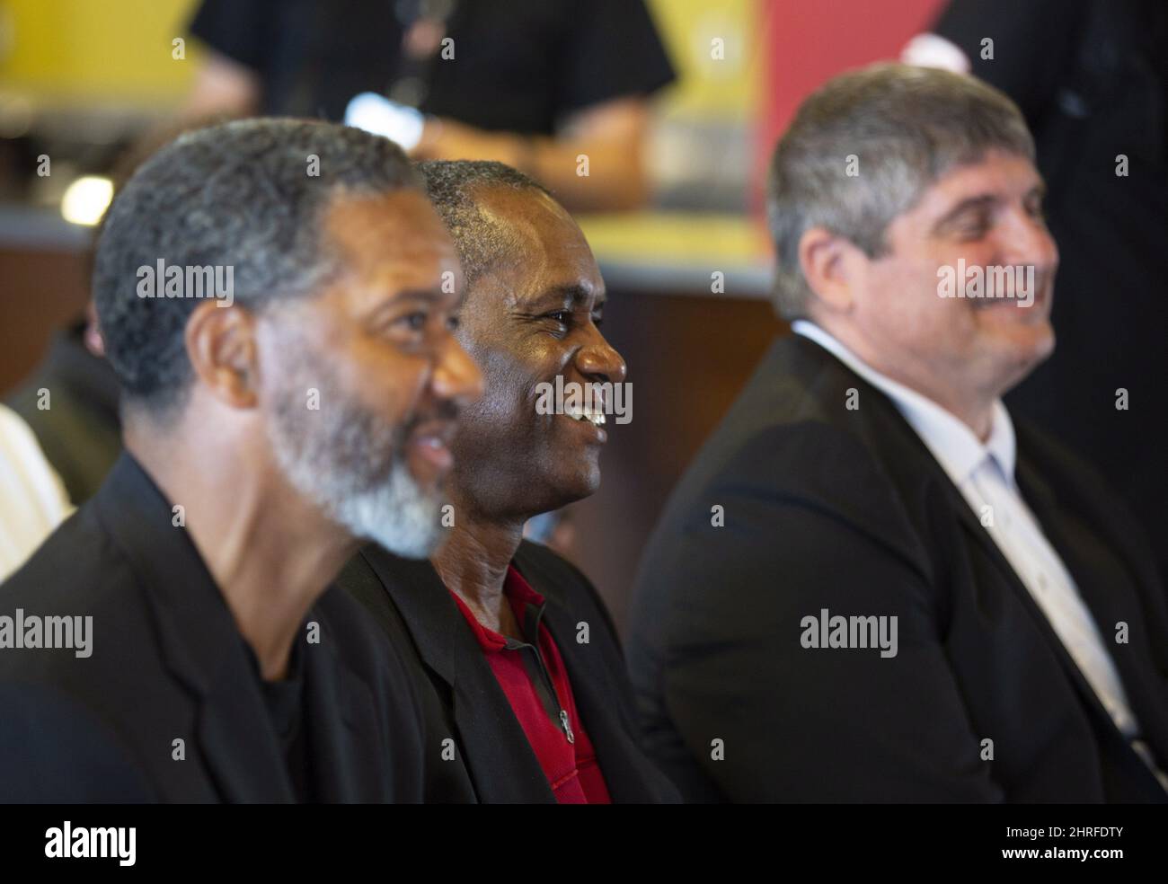 Former CFL player Less Browne, middle, smiles with fellow inductees ...