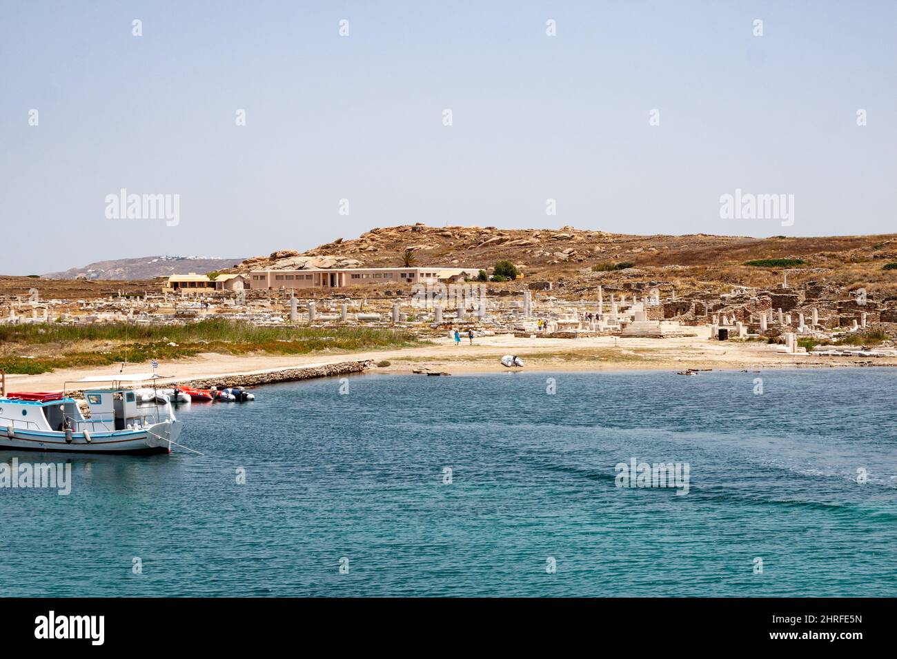Beautiful view of boats and the Greek ruins of the archaeological site ...