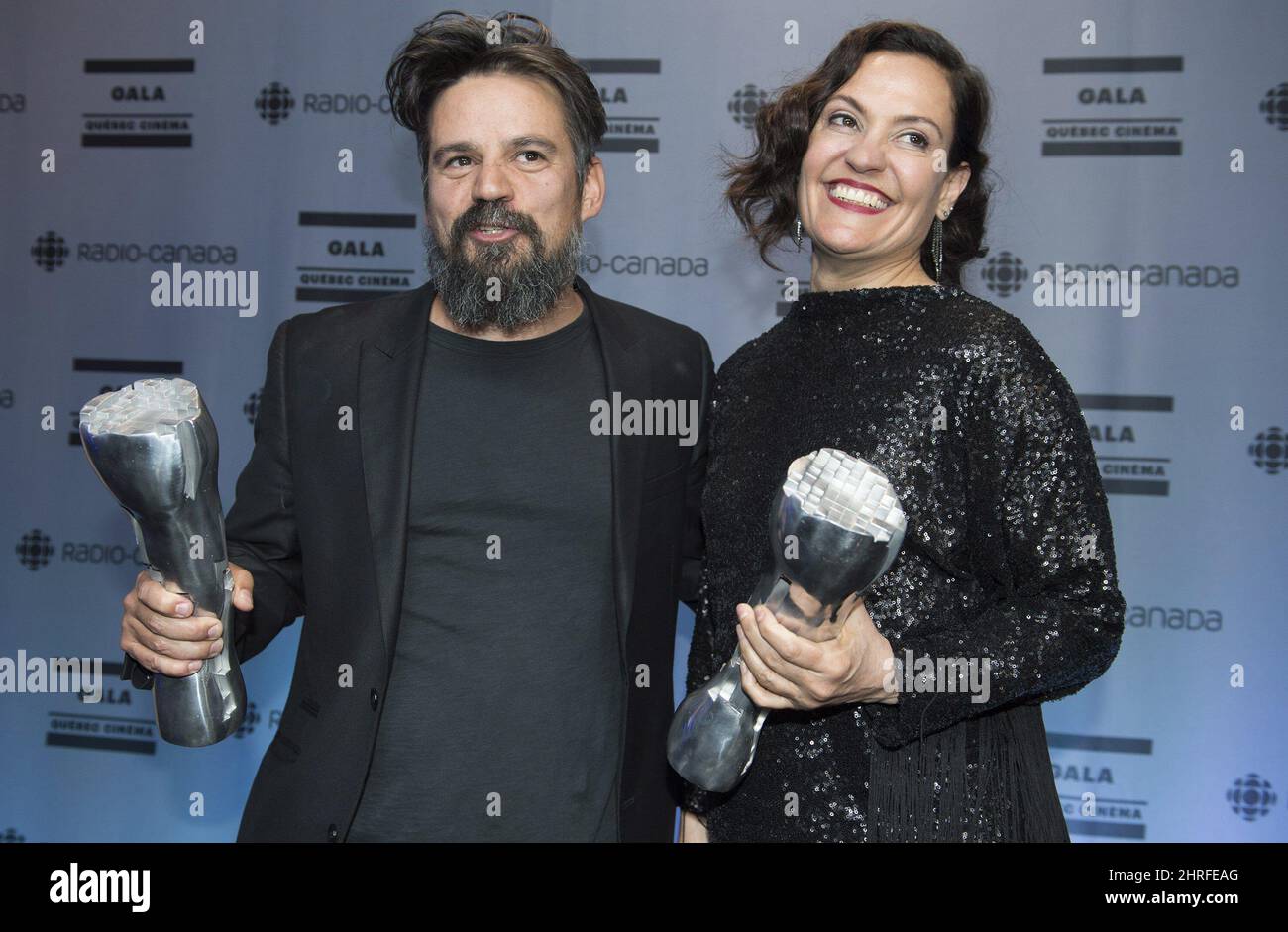 Robin Aubert holds up his Iris trophy for best director with actress ...