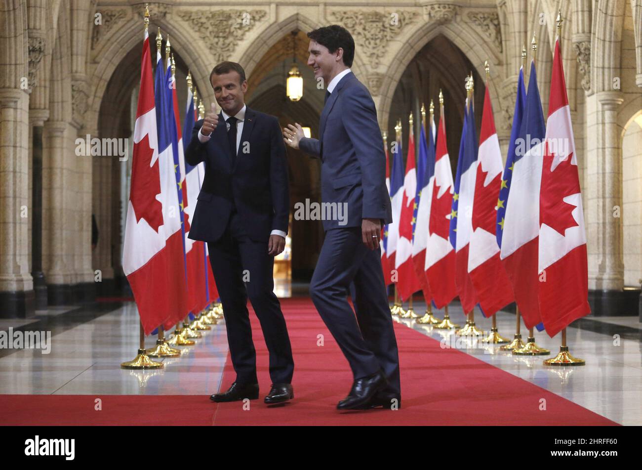 Prime Minister Justin Trudeau and French President Emmanuel Macron walk ...