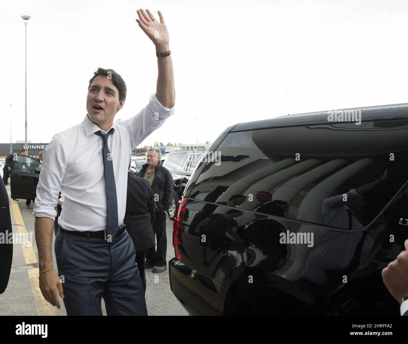 Prime Minister Justin Trudeau waves to people as he leaves a shopping ...