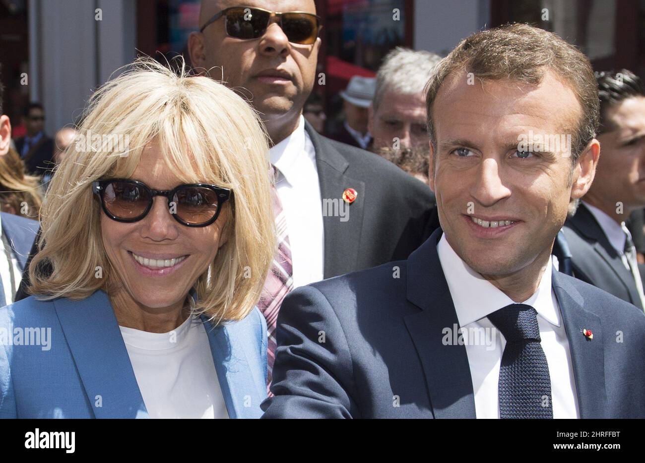French President Emmanuel Macron and wife Brigitte Macron smile as they ...