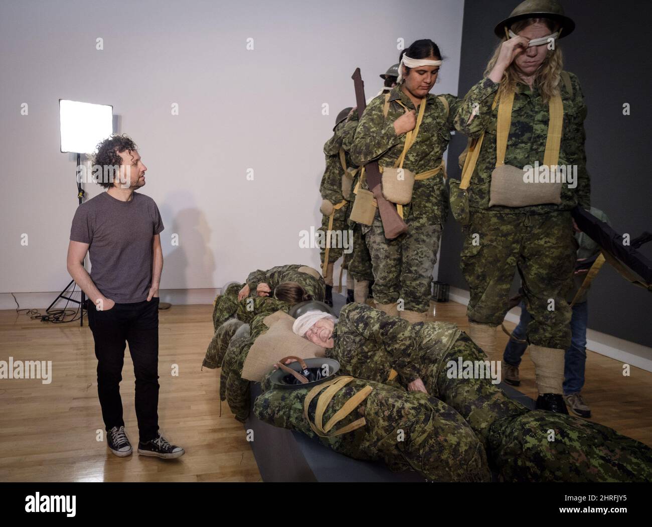 Volunteers help artist Adad Hannah, left, recreate the large oil ...