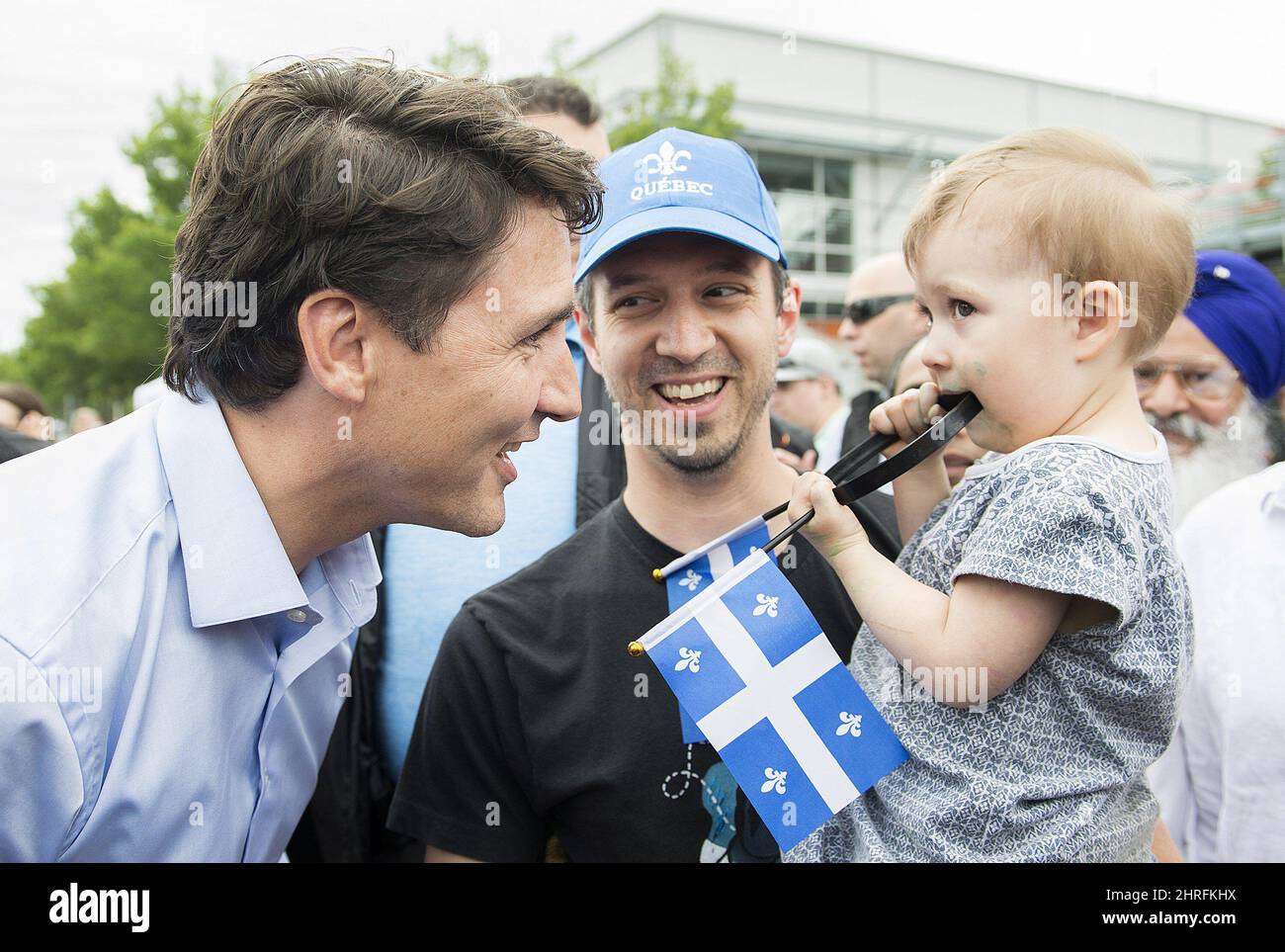 Prime Minister Justin Trudeau, left, greets a man and young girl during ...