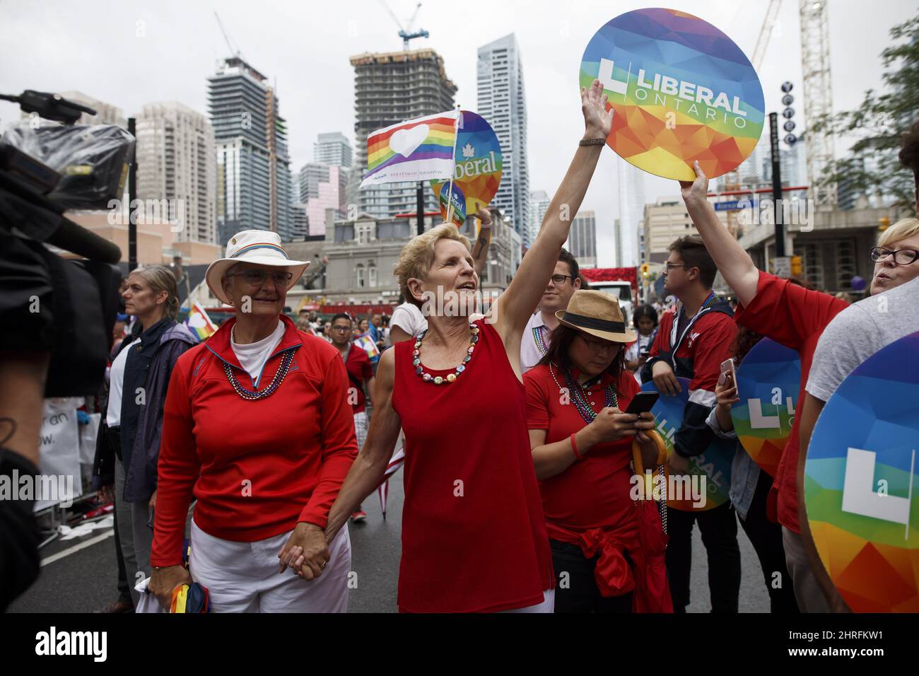Former Ontario premier Kathleen Wynne marches alongside her partner ...