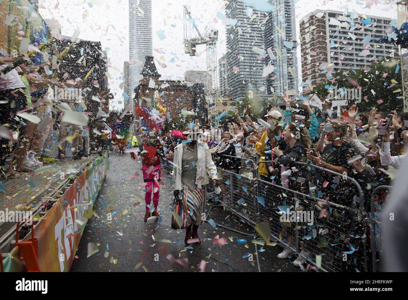 Confetti flies as revellers dance along the parade route during the ...