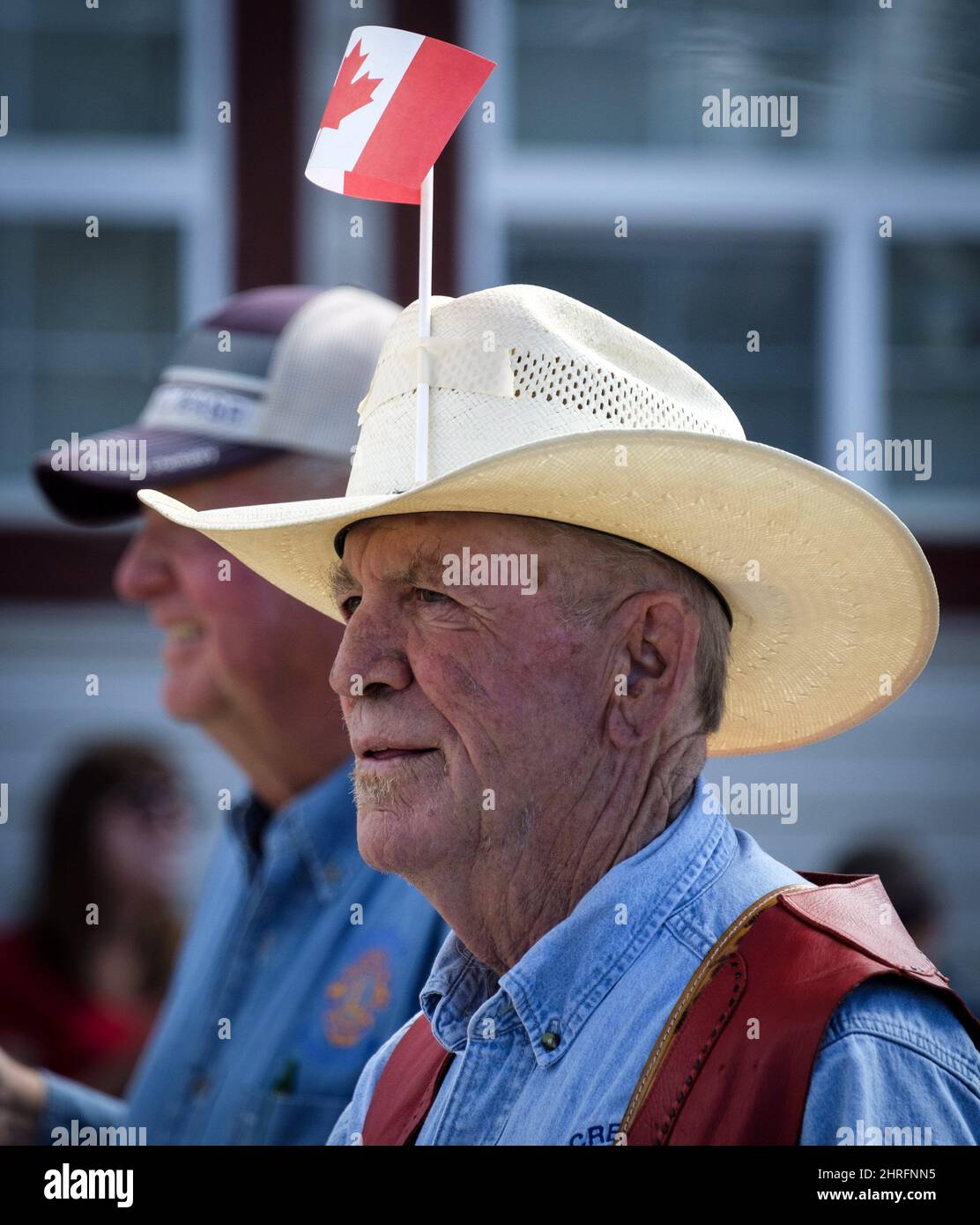A patriotic farmer wears a Canadian flag in his cowboy hat while ...