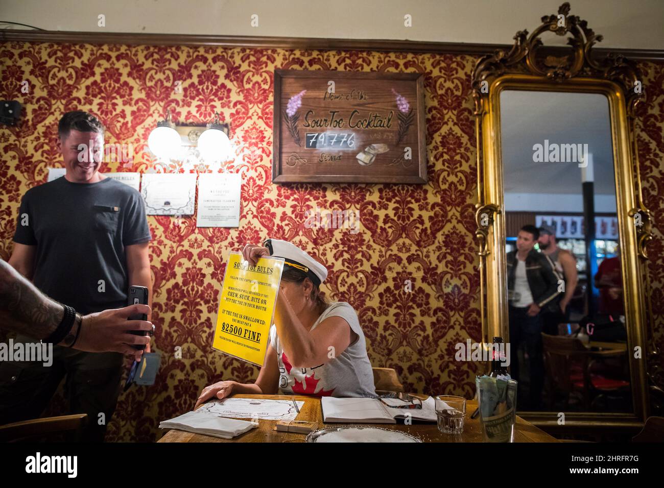 "Toe Captain" Sue Taylor holds up a list of rules while administering ...