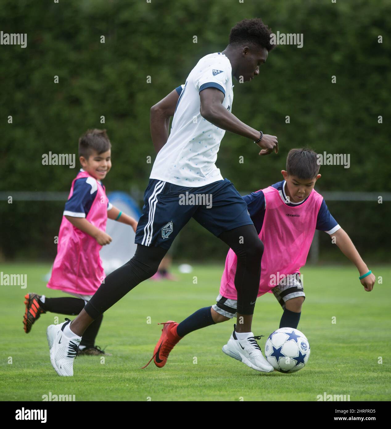Vancouver Whitecaps midfielder Alphonso Davies, front, plays soccer ...