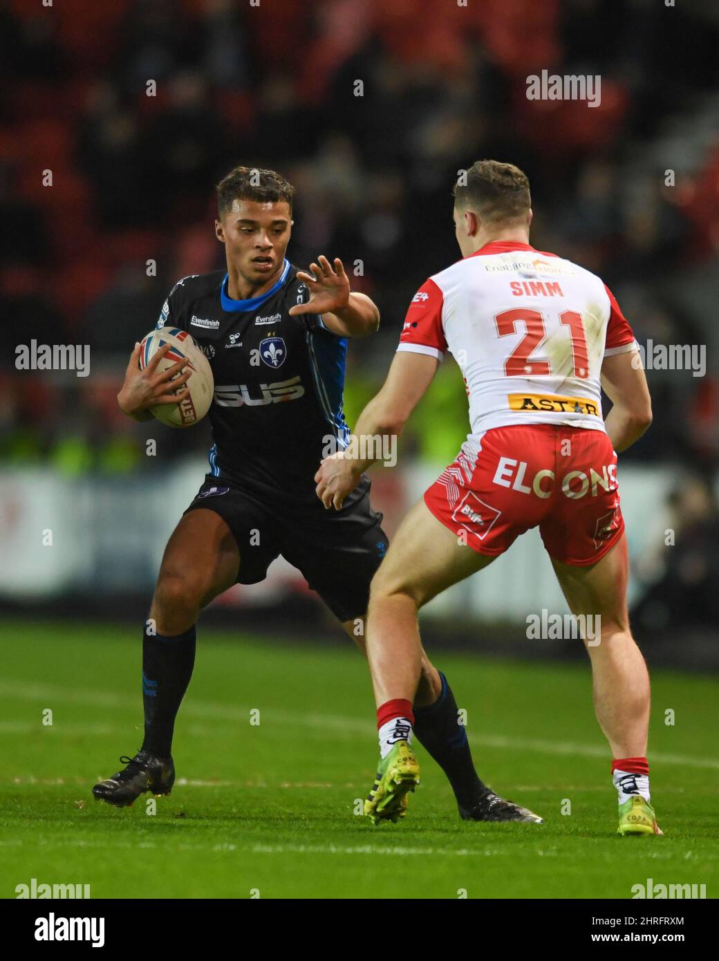 Corey Hall #30 of Wakefield Trinity looks for a way past Josh Simm #21 ...