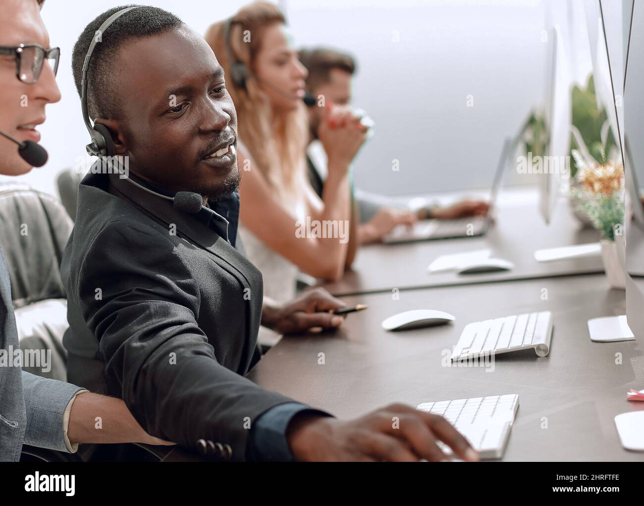 call center operators sitting at their Desk Stock Photo - Alamy