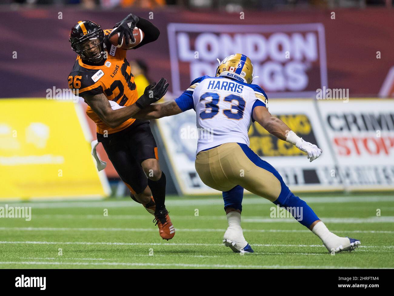 B.C. Lions' Anthony Orange, left, runs past Winnipeg Blue Bombers ...