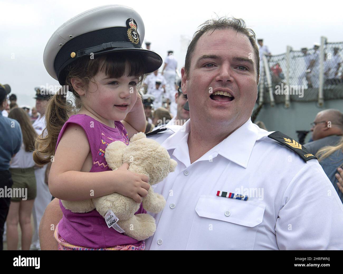 Petty Officer Second Class Robert Sinclair holds his daughter Harper ...