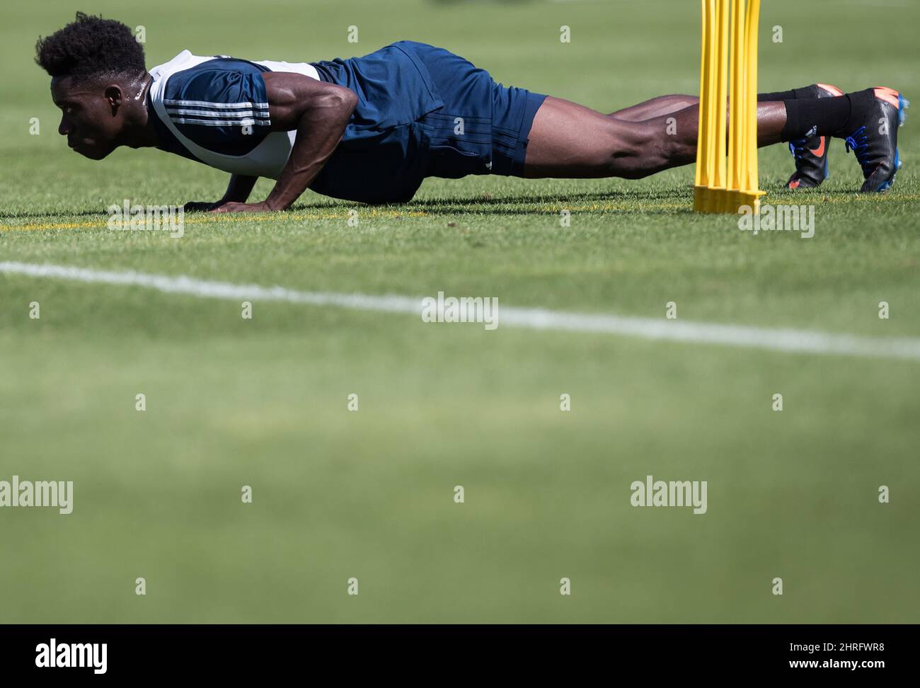 Vancouver Whitecaps midfielder Alphonso Davies does push-ups during MLS ...